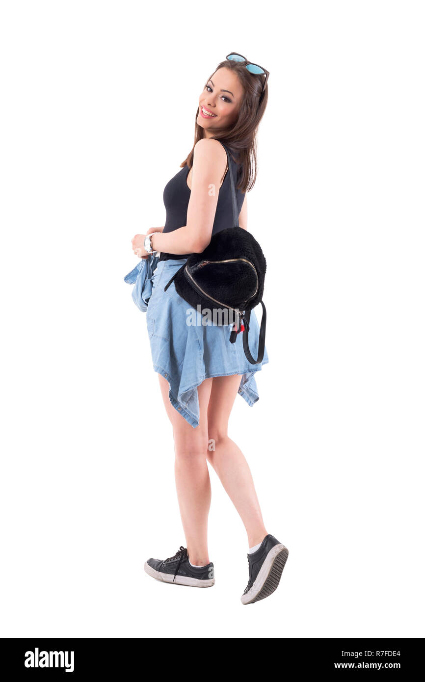 Back side view of trendy beautiful young flirty woman turning and ...