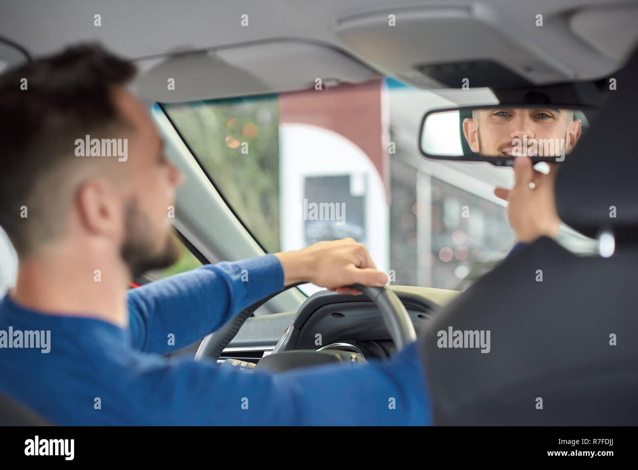 Handsome driver cheking everything in vehicle before ride. Brunette man ...