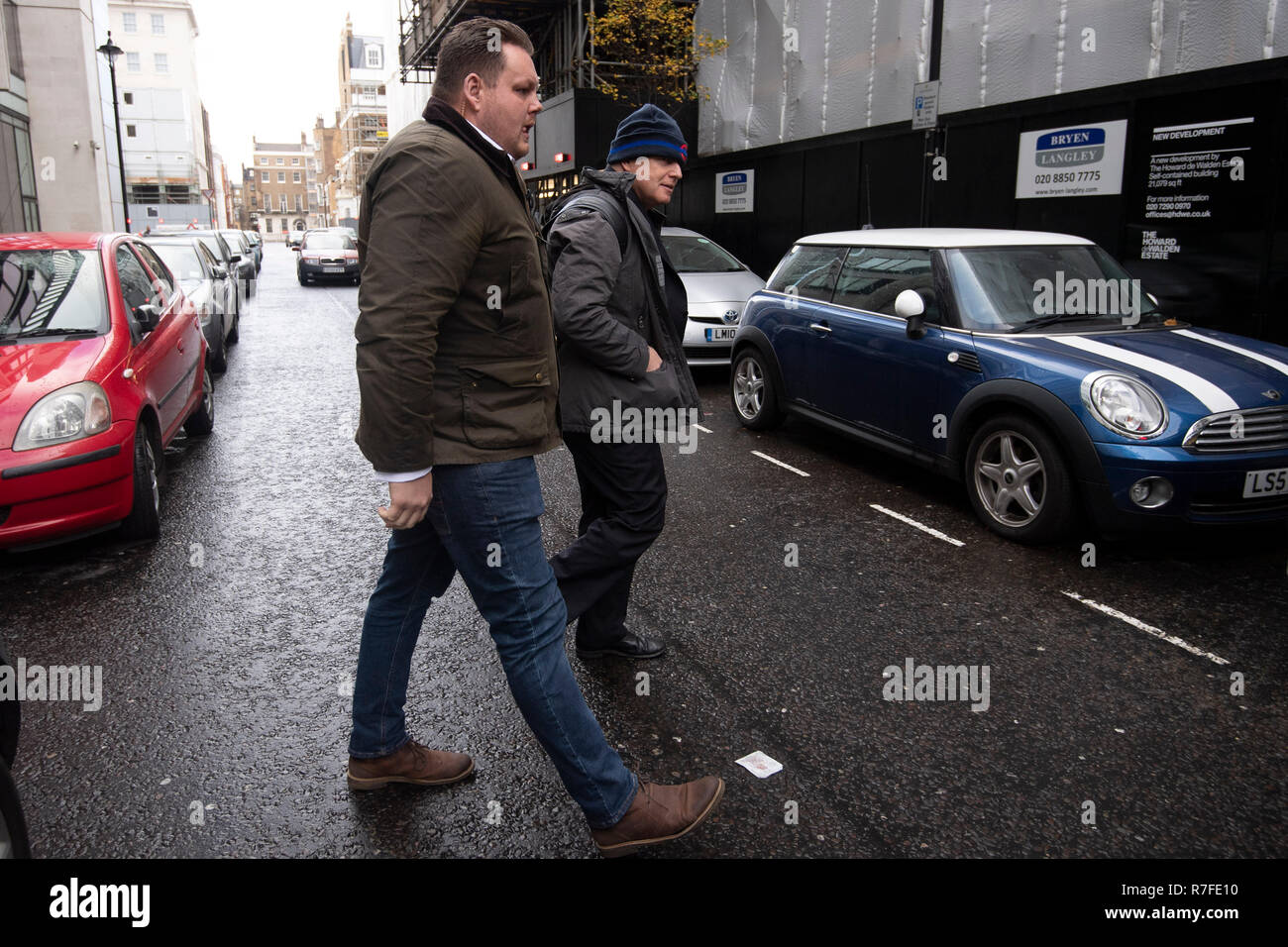 Boris Johnson is accompanied by a BBC security guard as he leaves BBC ...