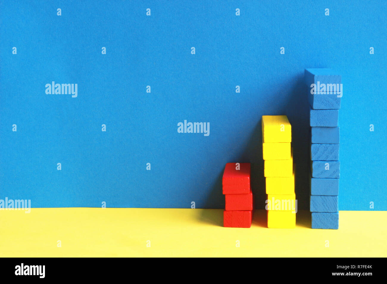 towers of red, yellow and blue toy blocks with different heights ...