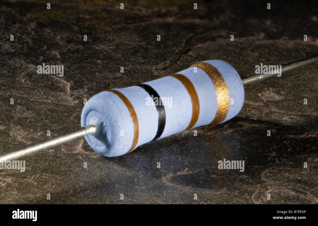 Resistor with wire leads on a dark stone background Stock Photo - Alamy