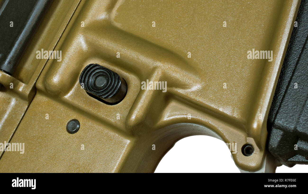 Black magazine release on a gold colored AR-15 Stock Photo - Alamy