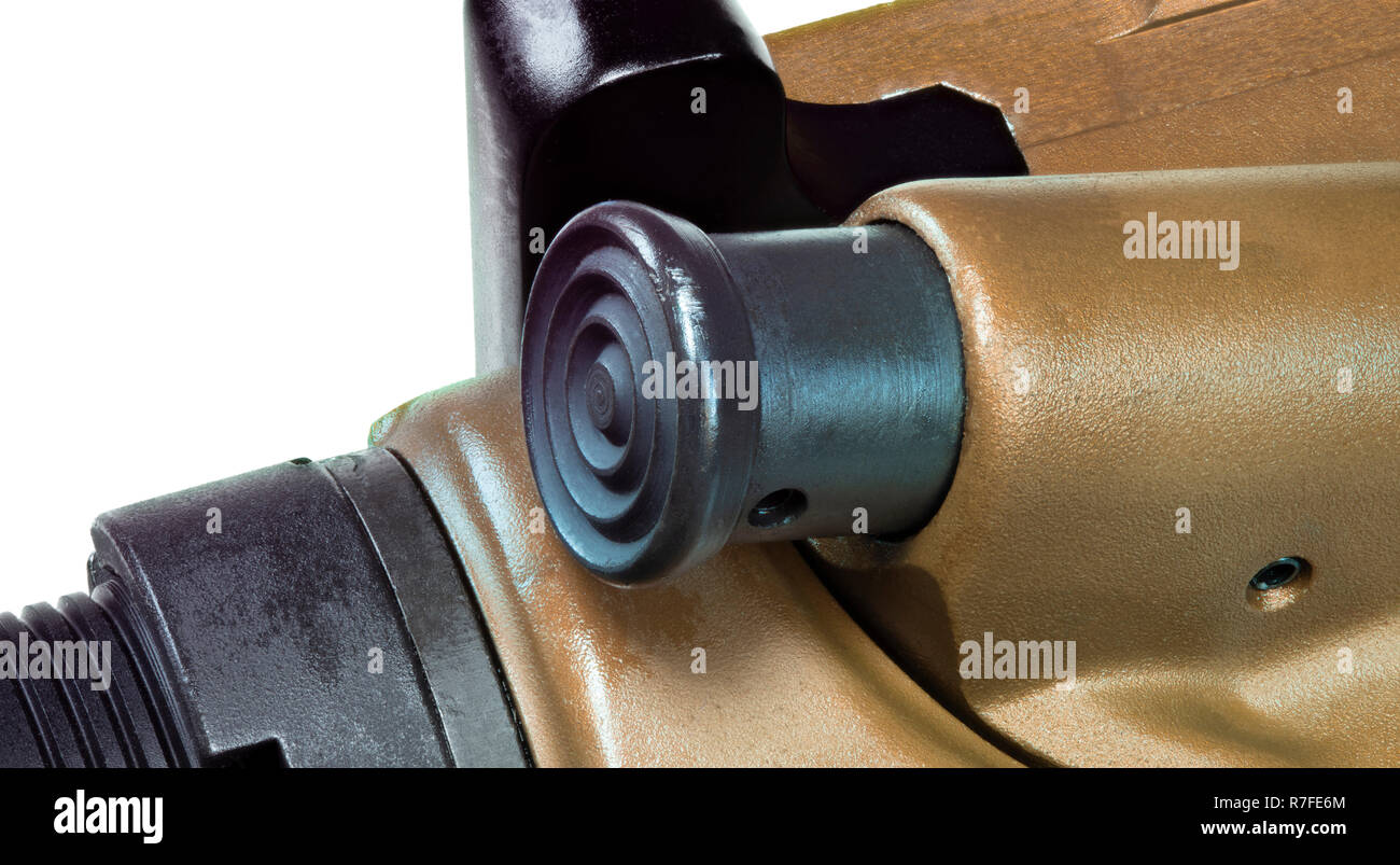 Forward assist on an AR-15 that is gold in color Stock Photo - Alamy