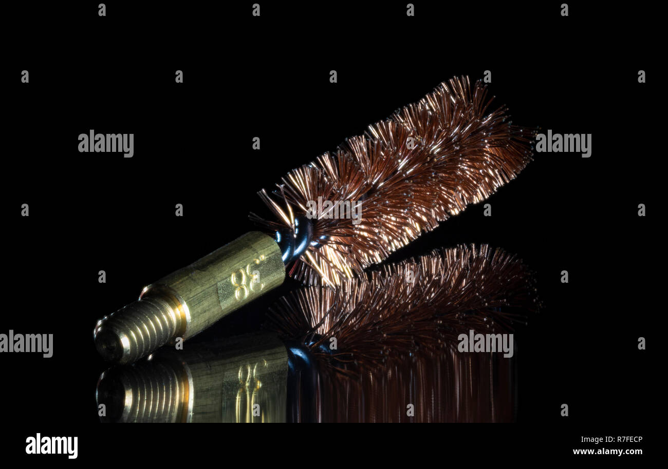 Wire brush for cleaning a thirty eight caliber gun on a black ...