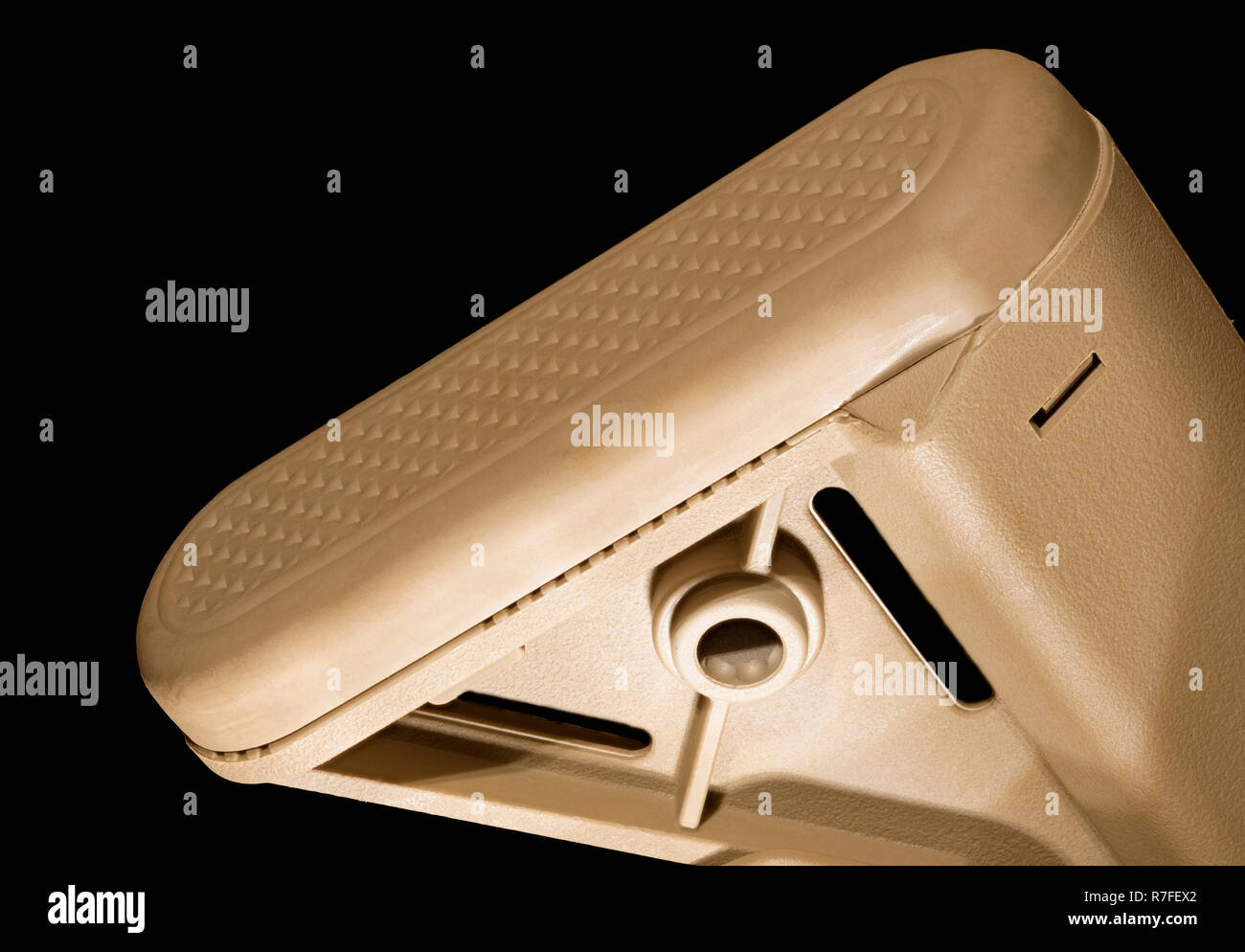 Tan colored recoil pad from an AR-15 on a black background Stock Photo ...