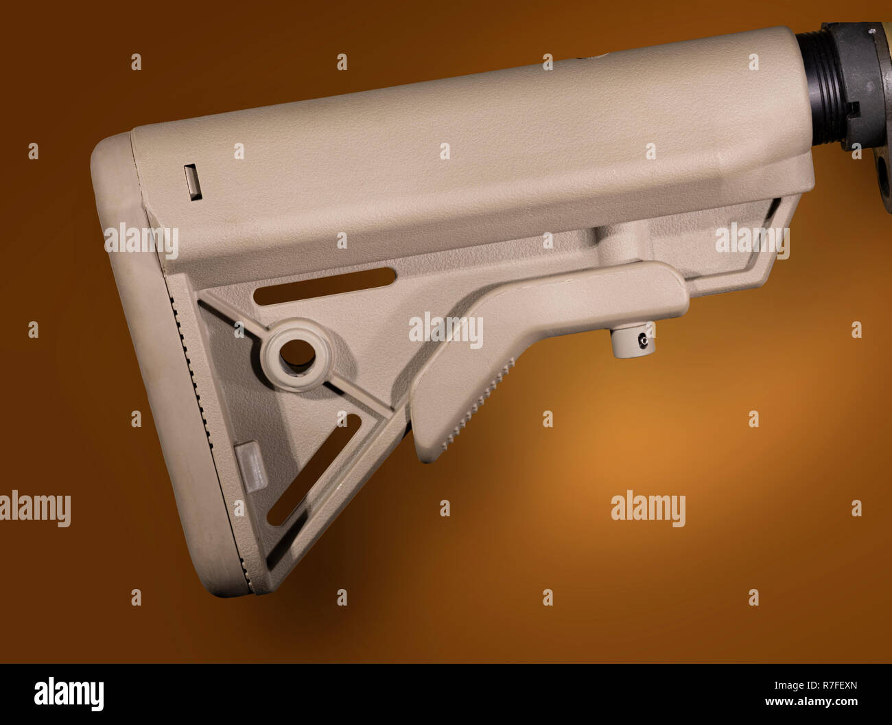 Beige adjustable stock for an AR-15 on a tan background Stock Photo - Alamy