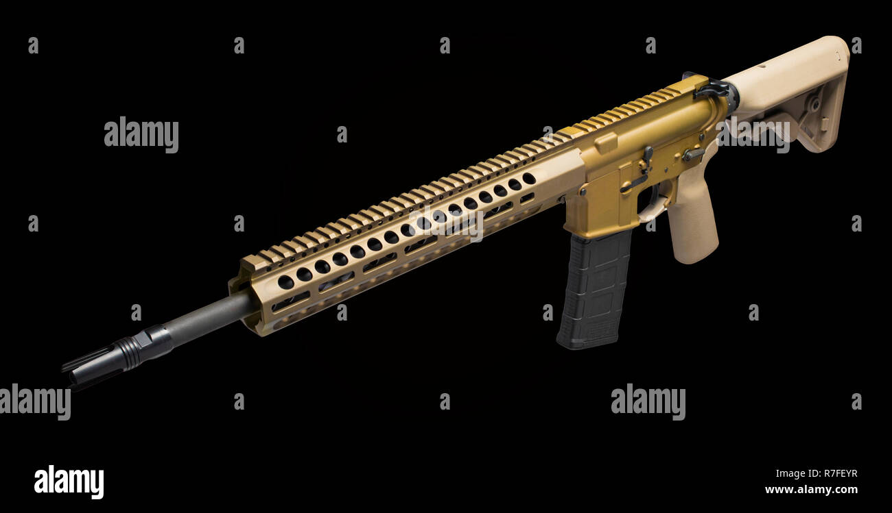 AR-15 with tan stock and pistol grip angled on a black background Stock ...
