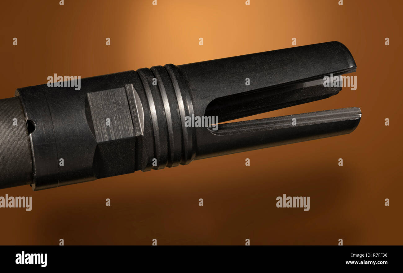 Flash hider on an AR-115 with a shadow on the tan background Stock ...