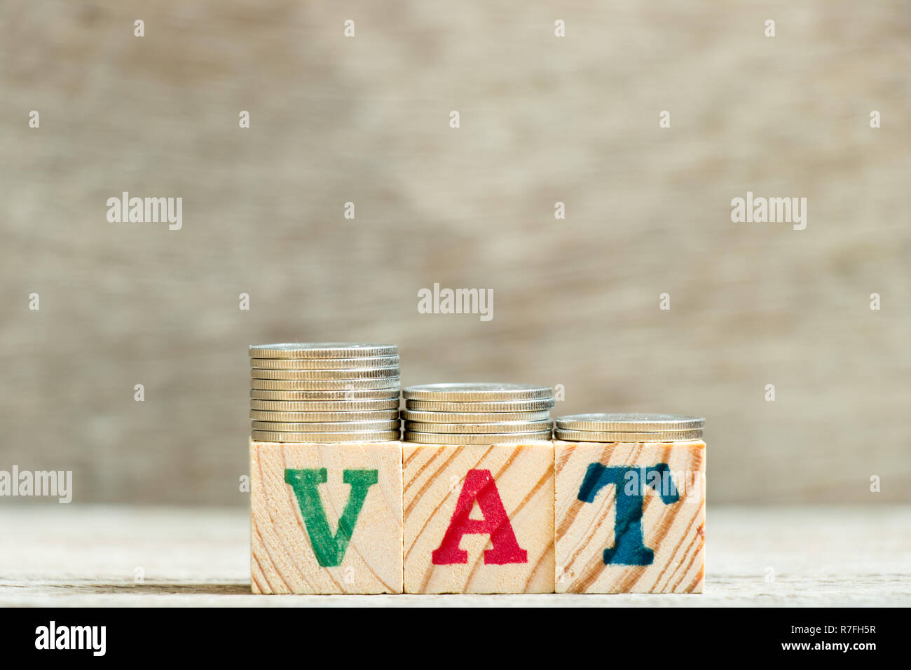 Block in word VAT (Abbreviation of Value added tax) with coin in down ...