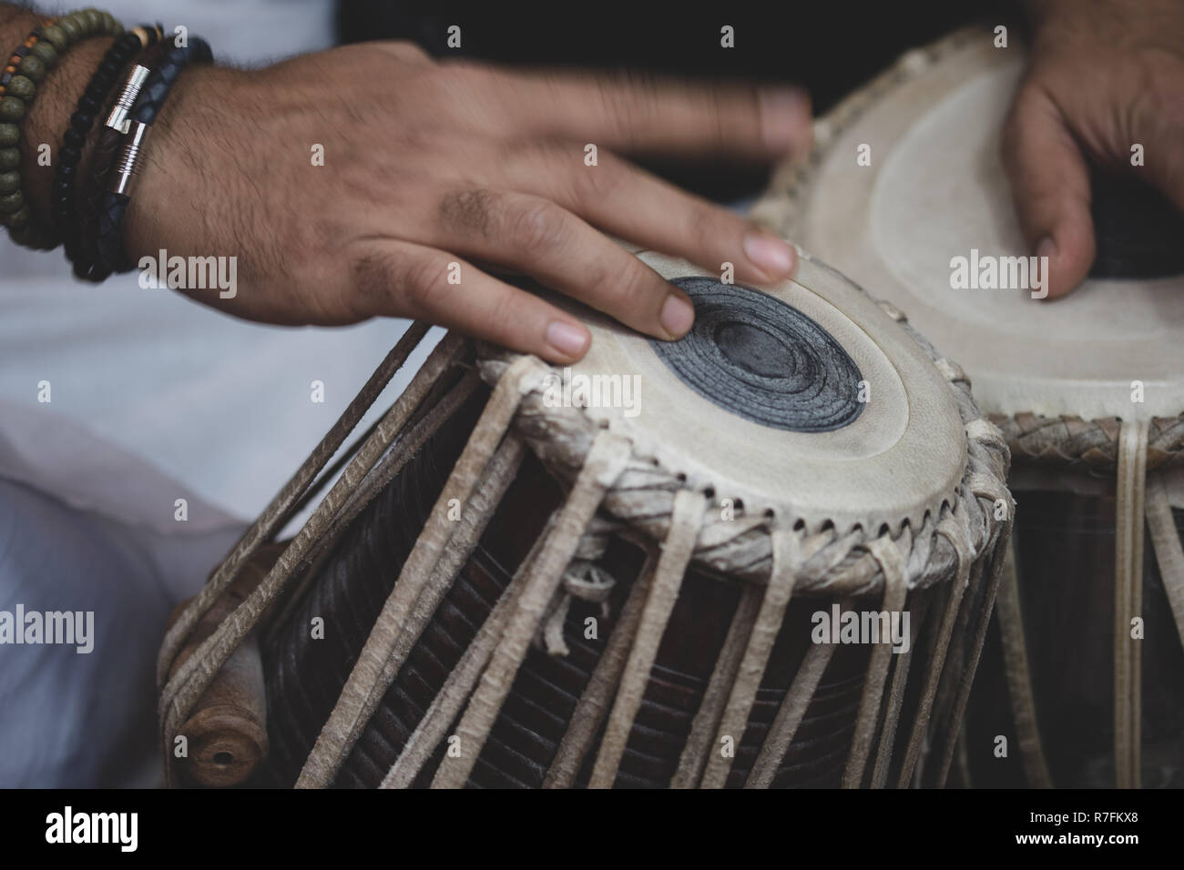 Image of a man's hands (wearing beads) playing the Tabla - Indian ...