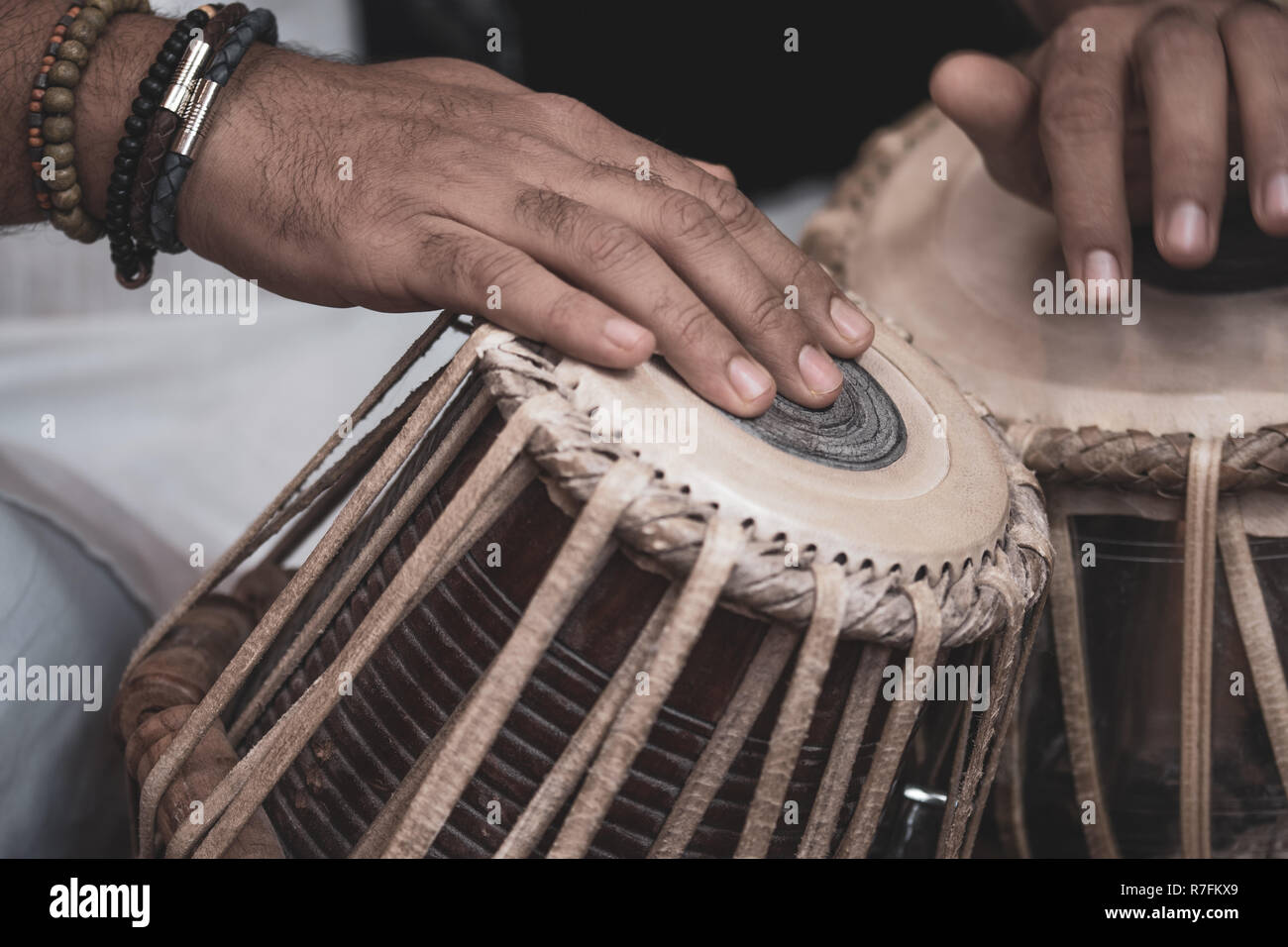 Image of a man's hands (wearing beads) playing the Tabla - Indian ...