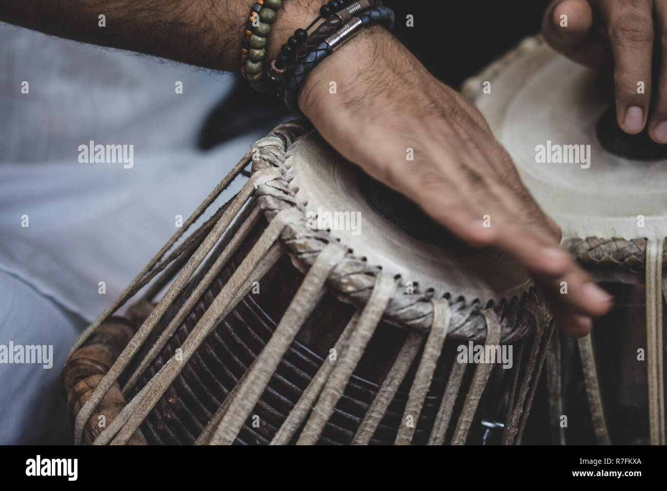 Image of a man's hands (wearing beads) playing the Tabla - Indian ...