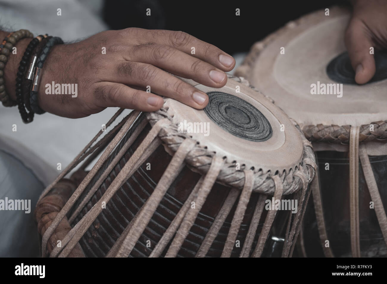 Image of a man's hands (wearing beads) playing the Tabla - Indian ...