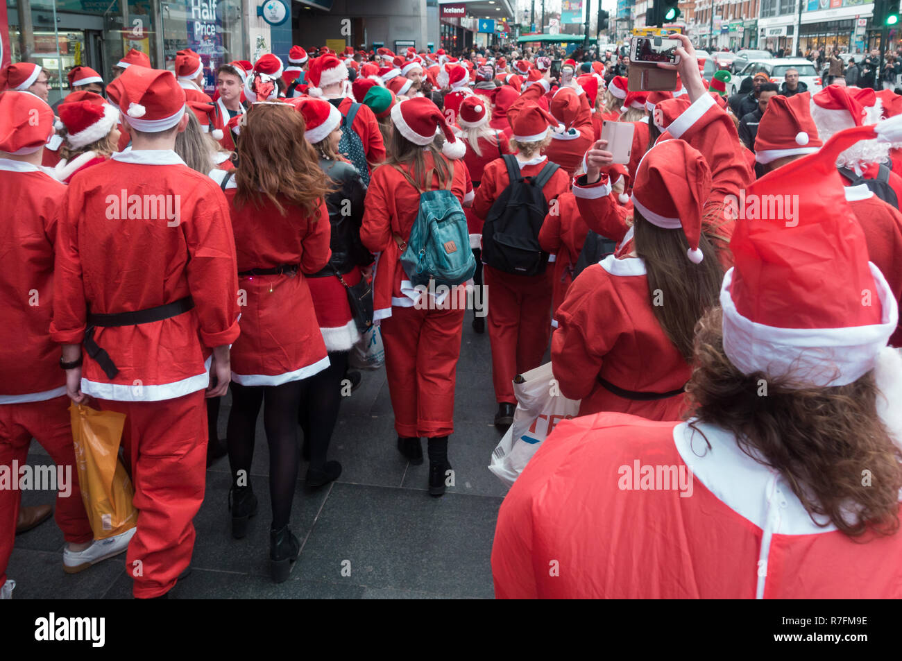 London, UK - December 2018 : Group of people dressed in santa outfits ...