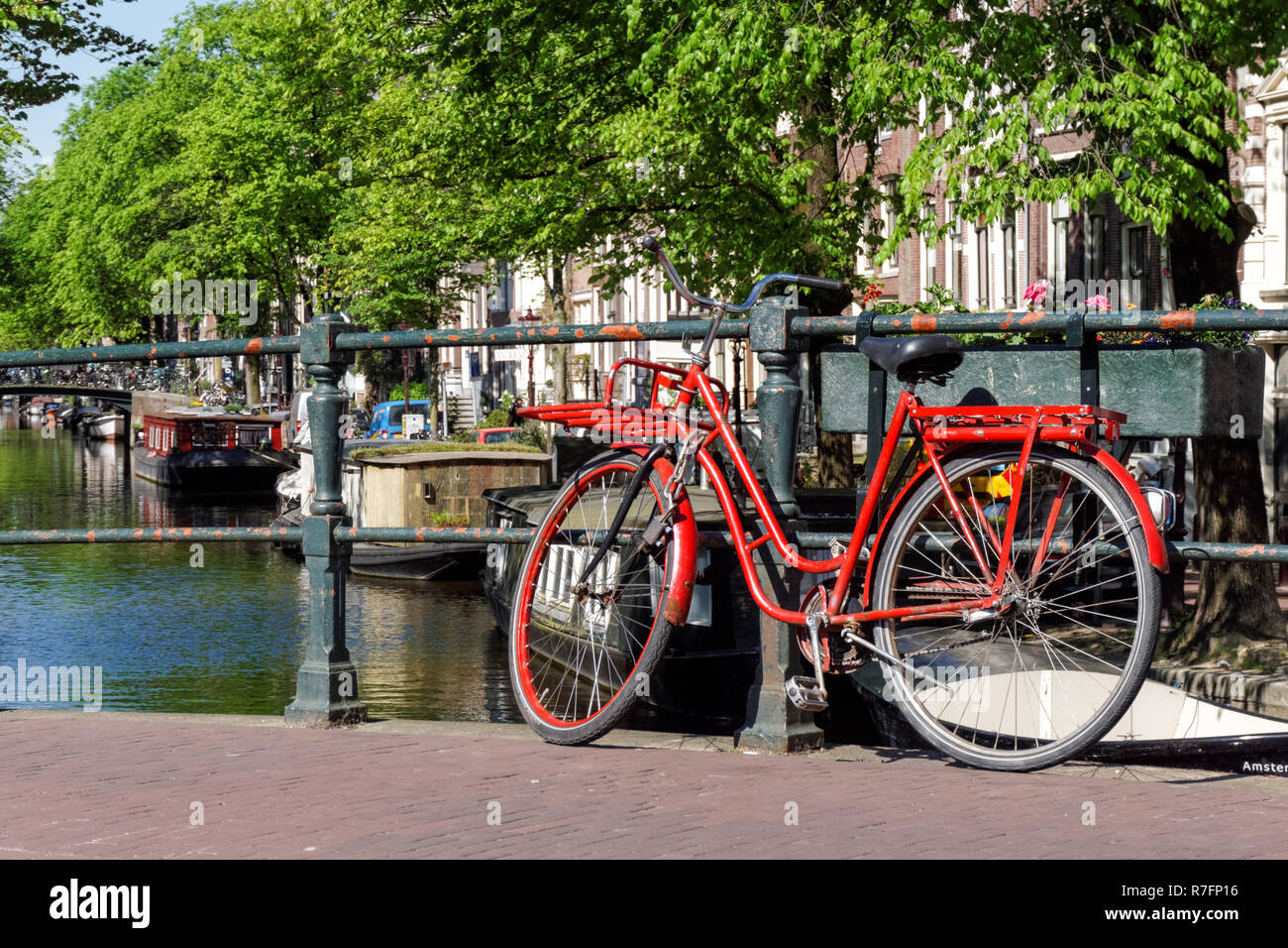 Traditional Dutch bike parked on a canal bridge in Amsterdam ...