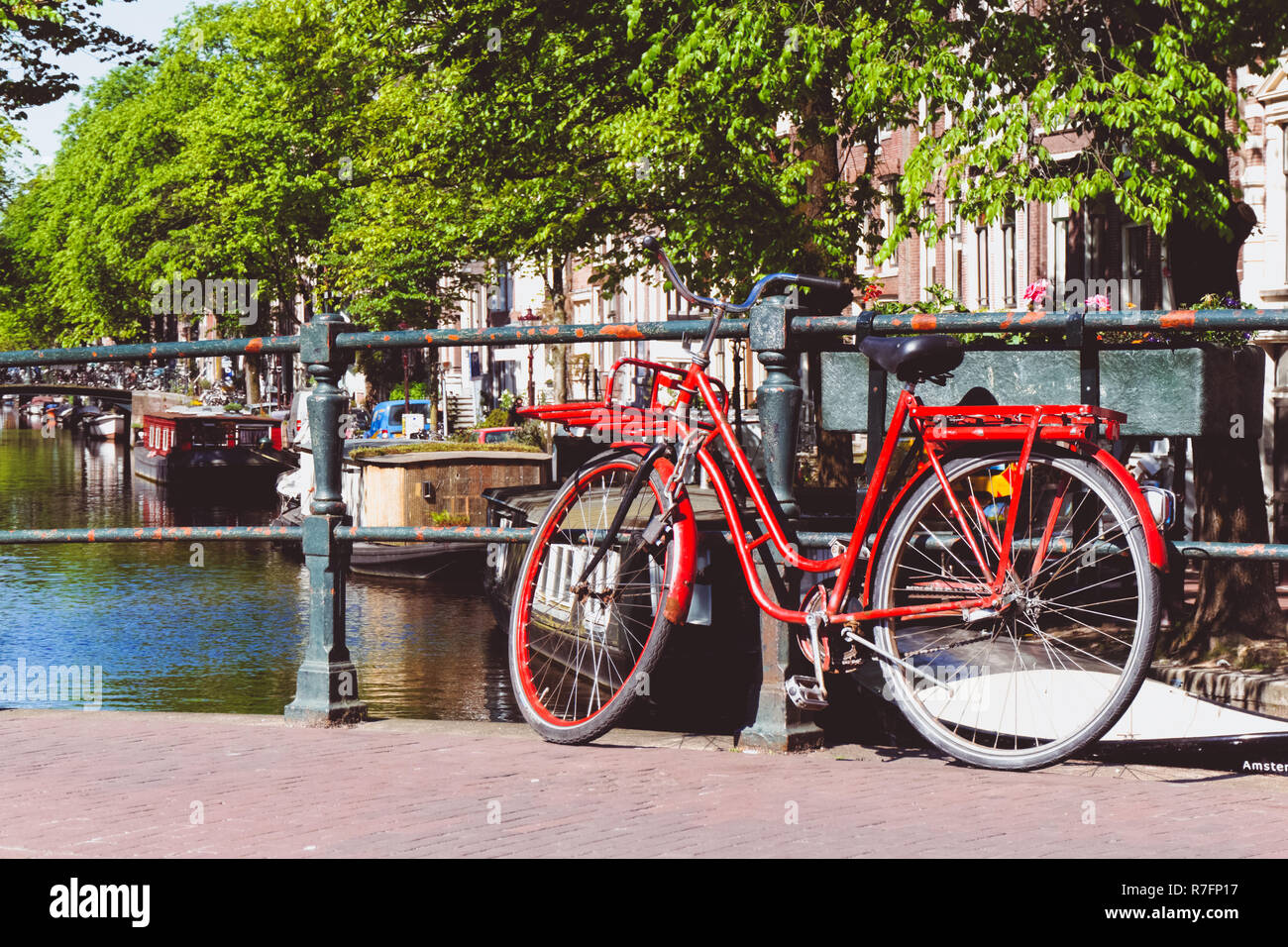 Traditional Dutch bike parked on a canal bridge in Amsterdam ...
