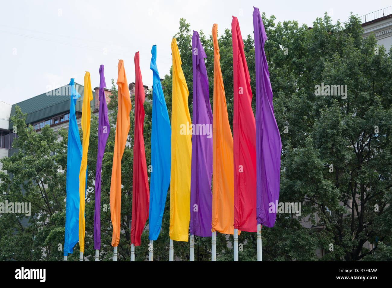 Colorful flags near green trees Stock Photo - Alamy