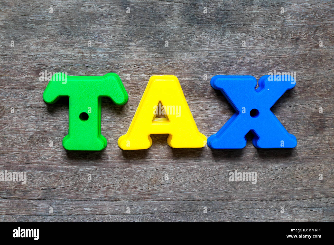 Color alphabet in word tax on wood background Stock Photo - Alamy
