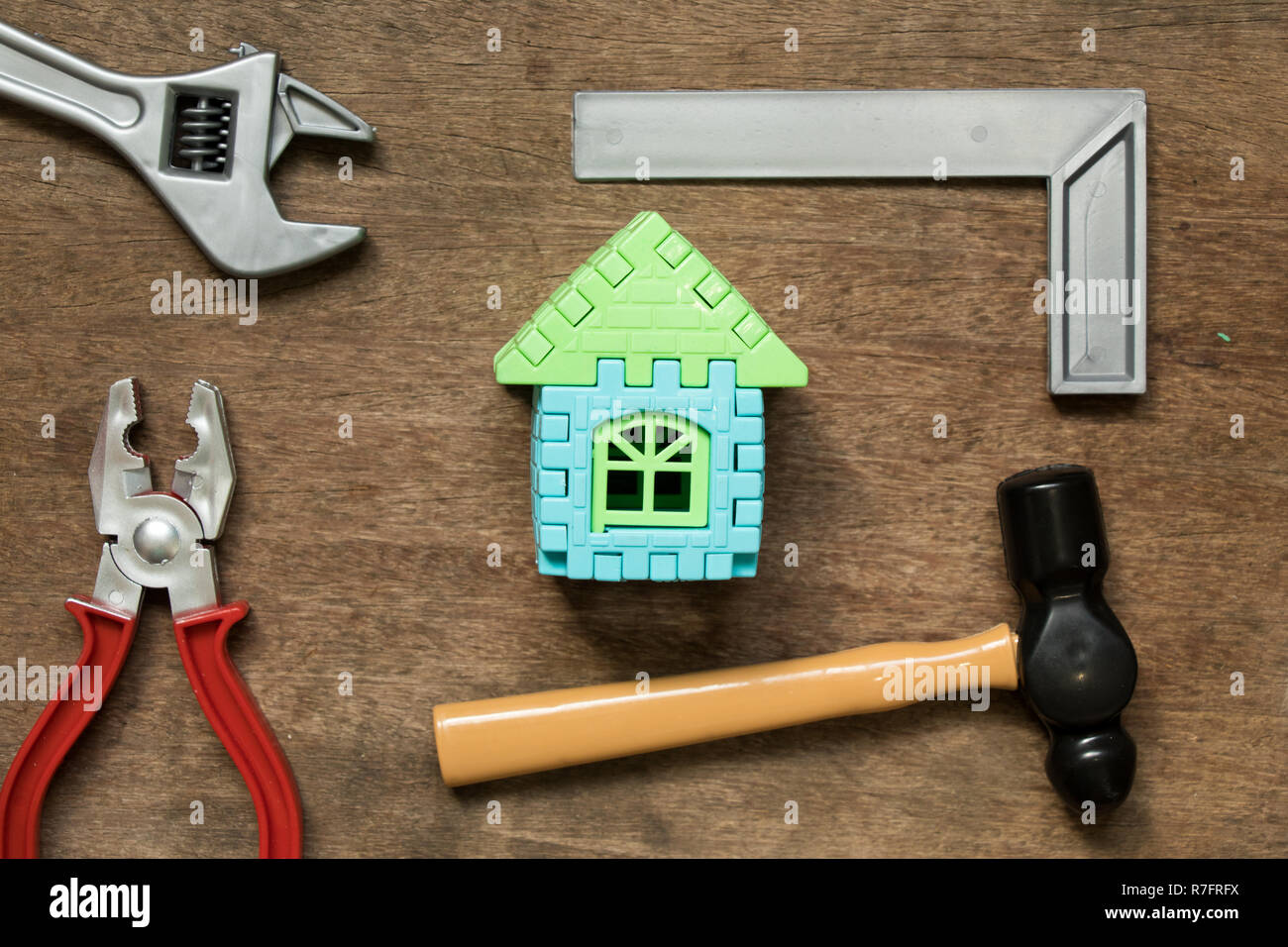 Home model object with toy equipment tool on wood background (Concept ...