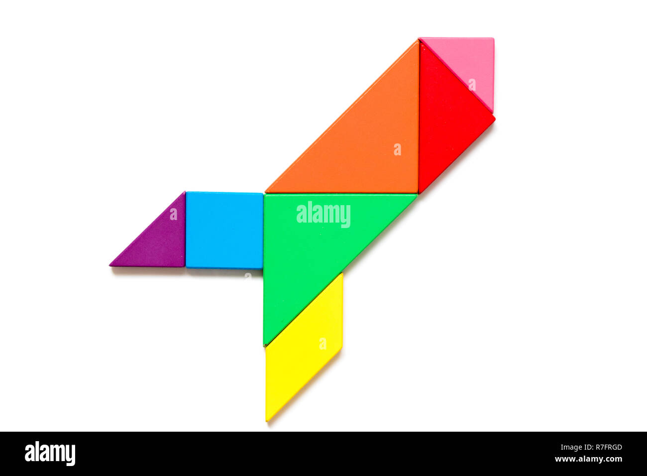 Color wood tangram puzzle in rocket or missile shape on white ...