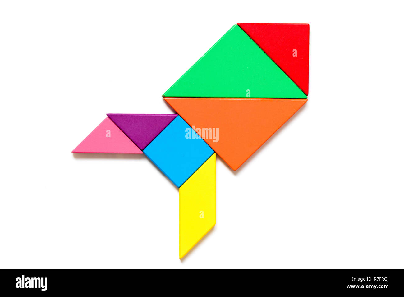 Color wood tangram puzzle in rocket or missile shape on white ...