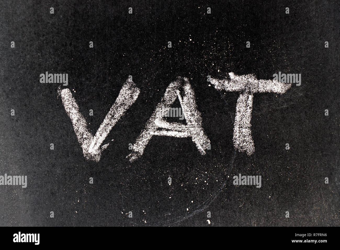 White chalk drawing in VAT (Value added tax) on black board background ...