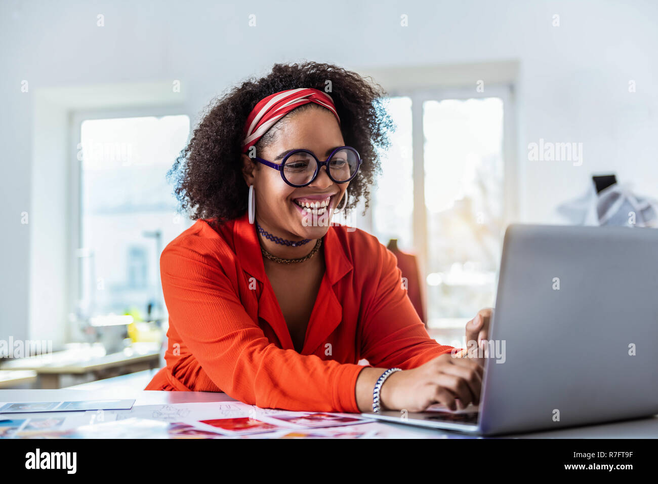 Short-haired African American woman openly laughing while sitting Stock ...