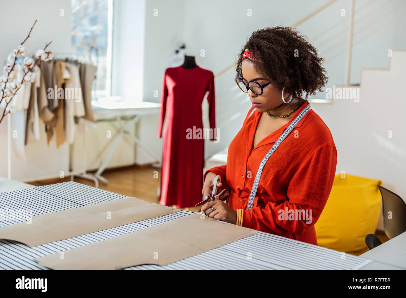 Concentrated appealing female designer creating model for costume Stock ...