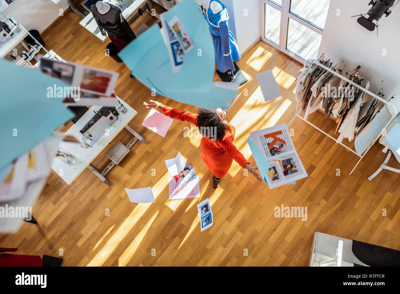 Cheerful young designer feeling free and happy while whirling Stock ...