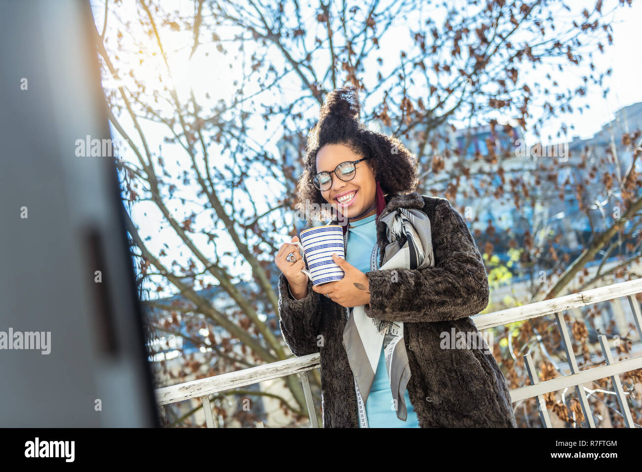 Happy bright African American woman carrying giant cup of coffee Stock ...