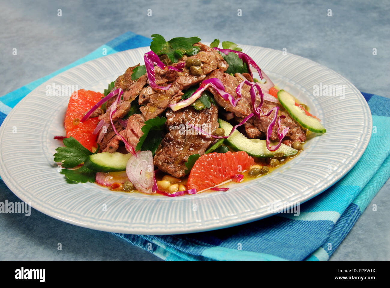 Barbecued beef steak salad with dressing Stock Photo - Alamy