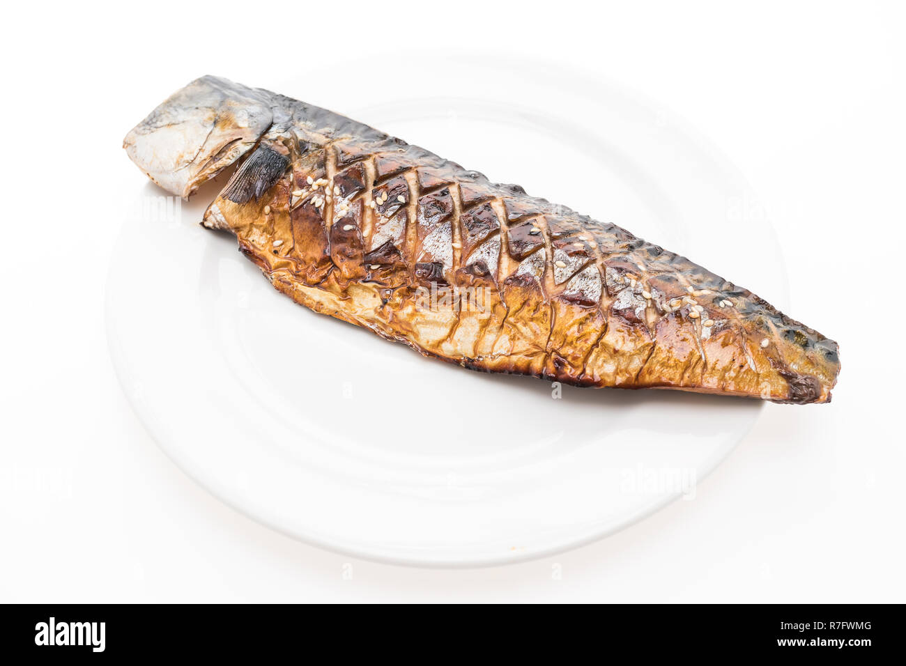 Grilled saba fish with sweet sauce in white plate isolated on white ...