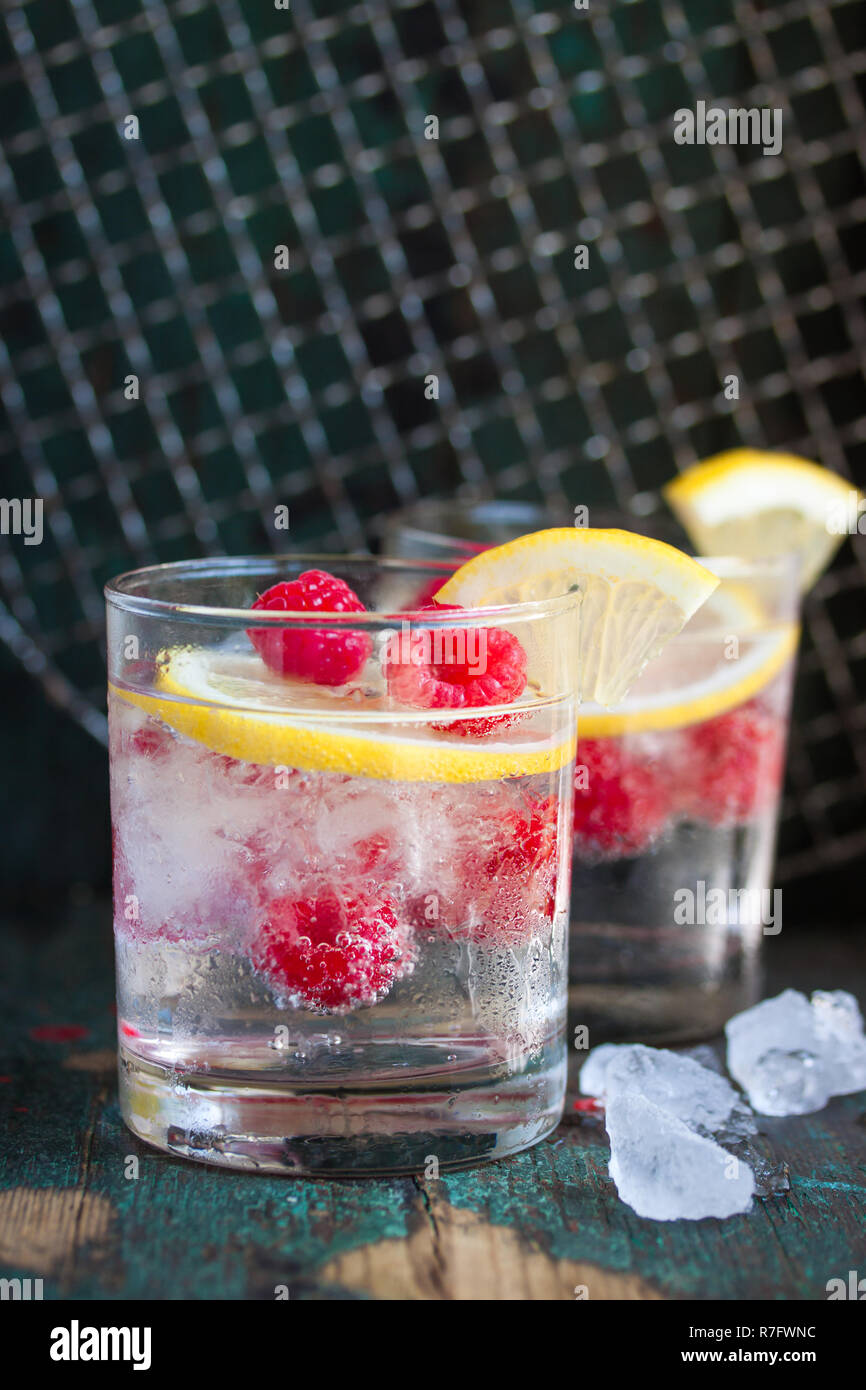 Homemade summer cold raspberry lemon cocktail with sparkling water and ...