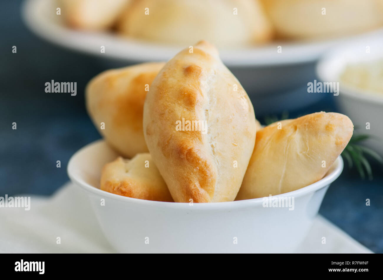 Small mashed potato pasties (hand pies) in a bowl on a parchment Stock ...