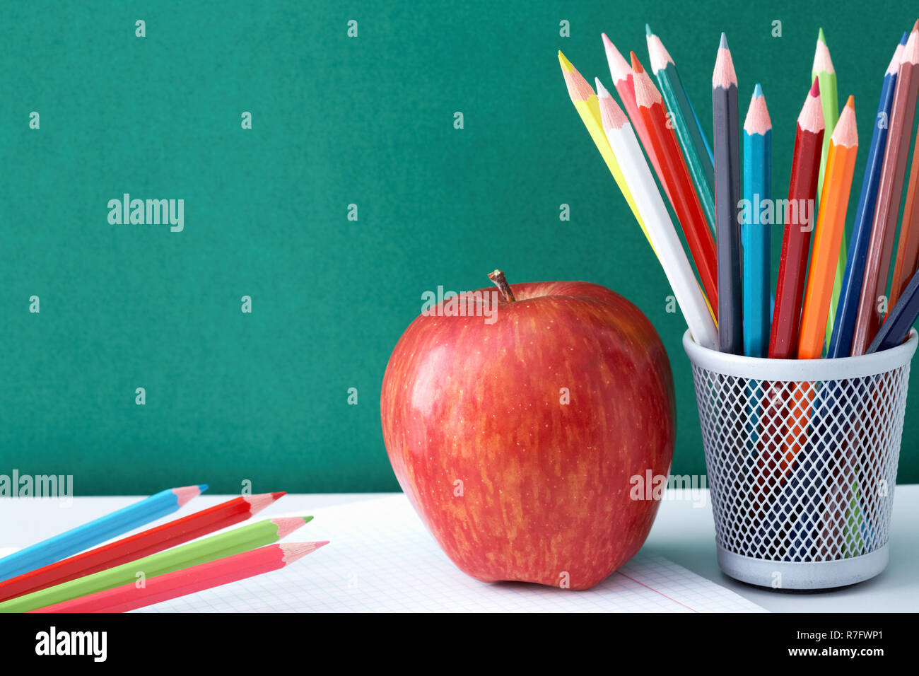 Image of crayons and red apple against blackboard Stock Photo - Alamy