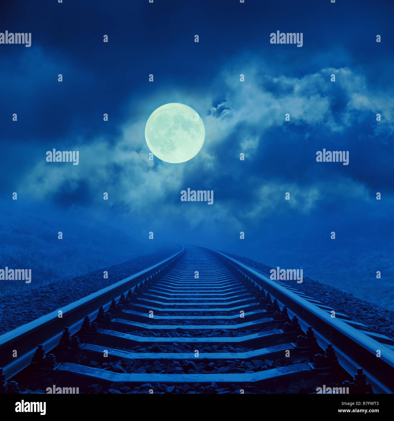 full moon in cloudy over night railroad Stock Photo - Alamy