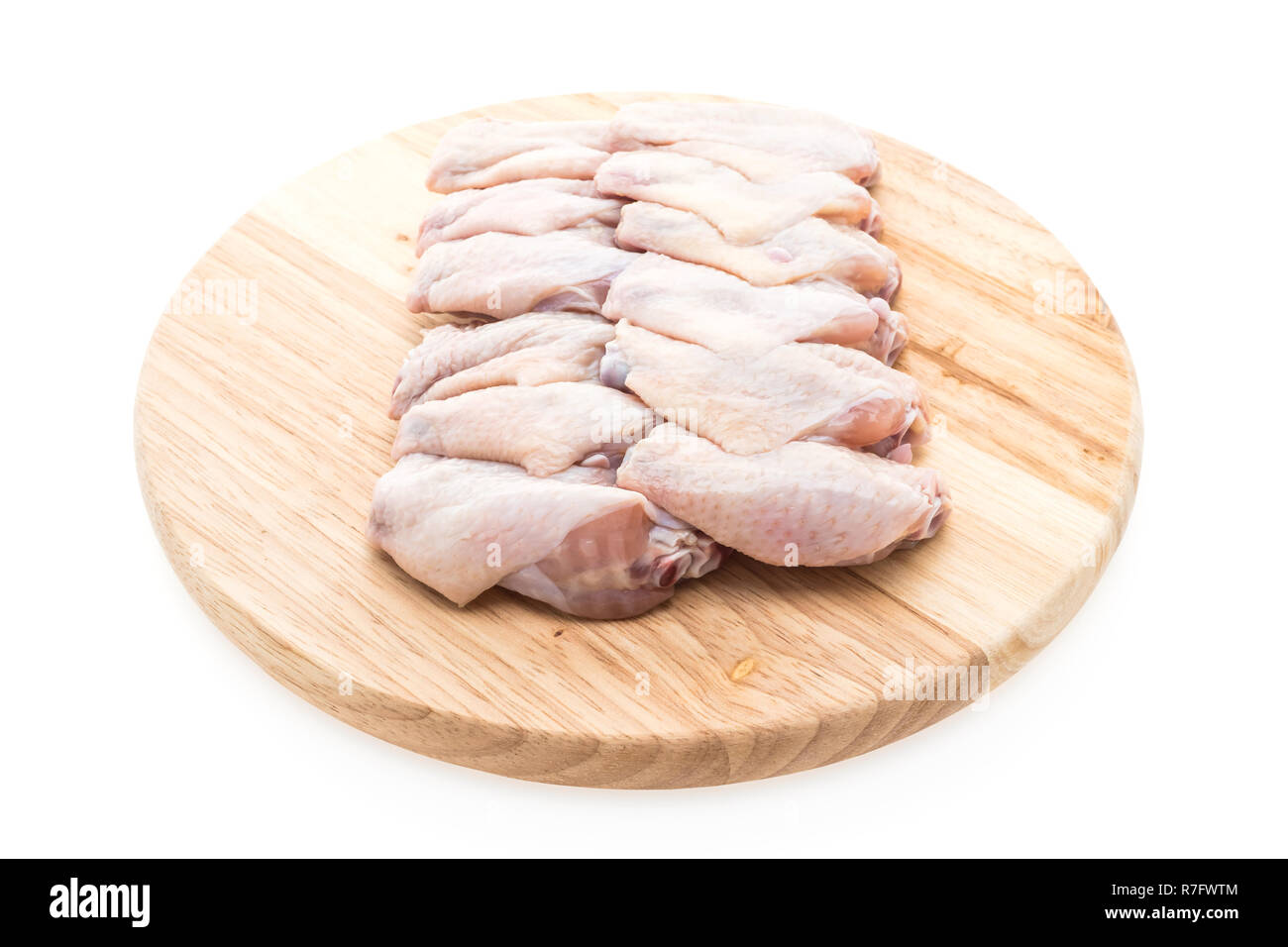 Raw fresh chicken wing meat on wooden cutting board isolated on white ...
