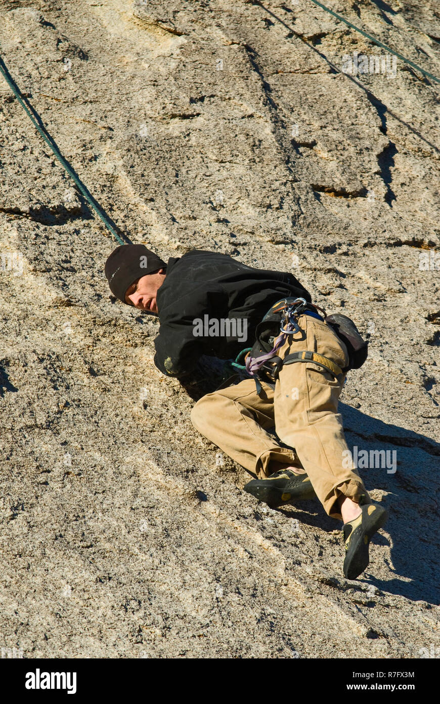 Rock climber scaling exposed rock face in Alabama Hills near Lone Pine ...