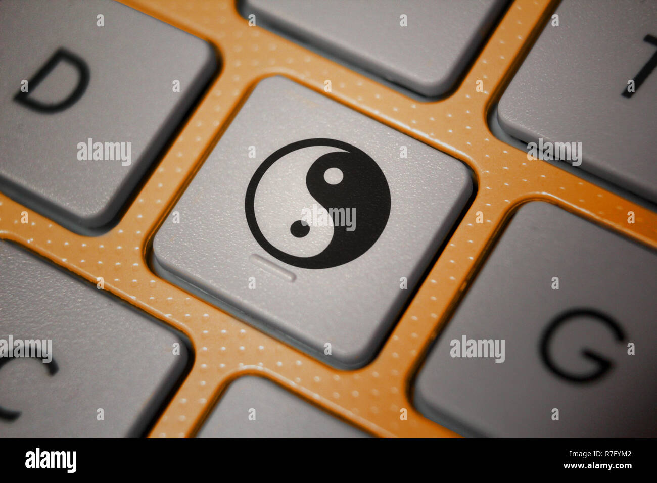 Image of ying-yang icon on computer keyboard Stock Photo - Alamy
