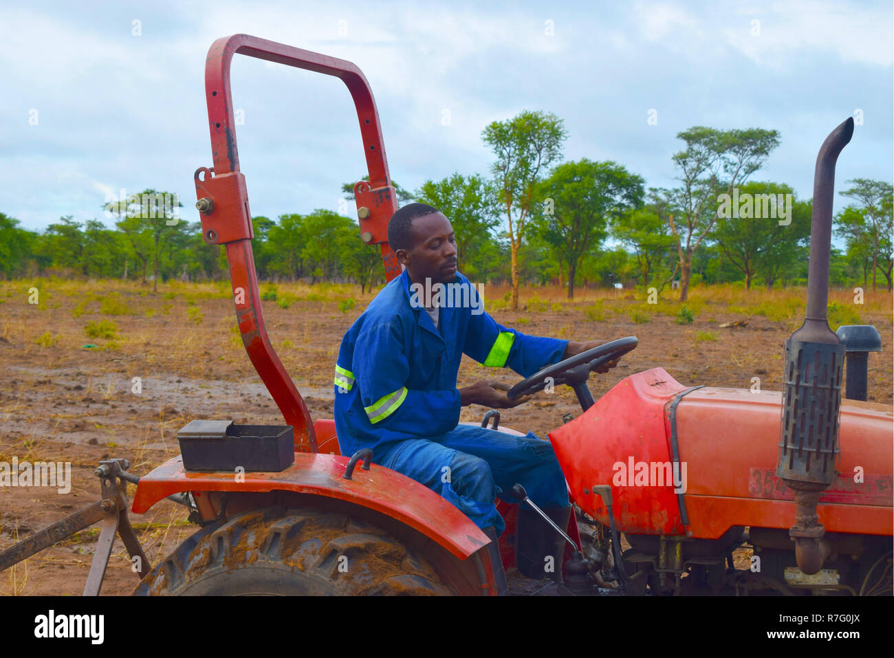 Male Farmer on a tractor in African field Stock Photo - Alamy