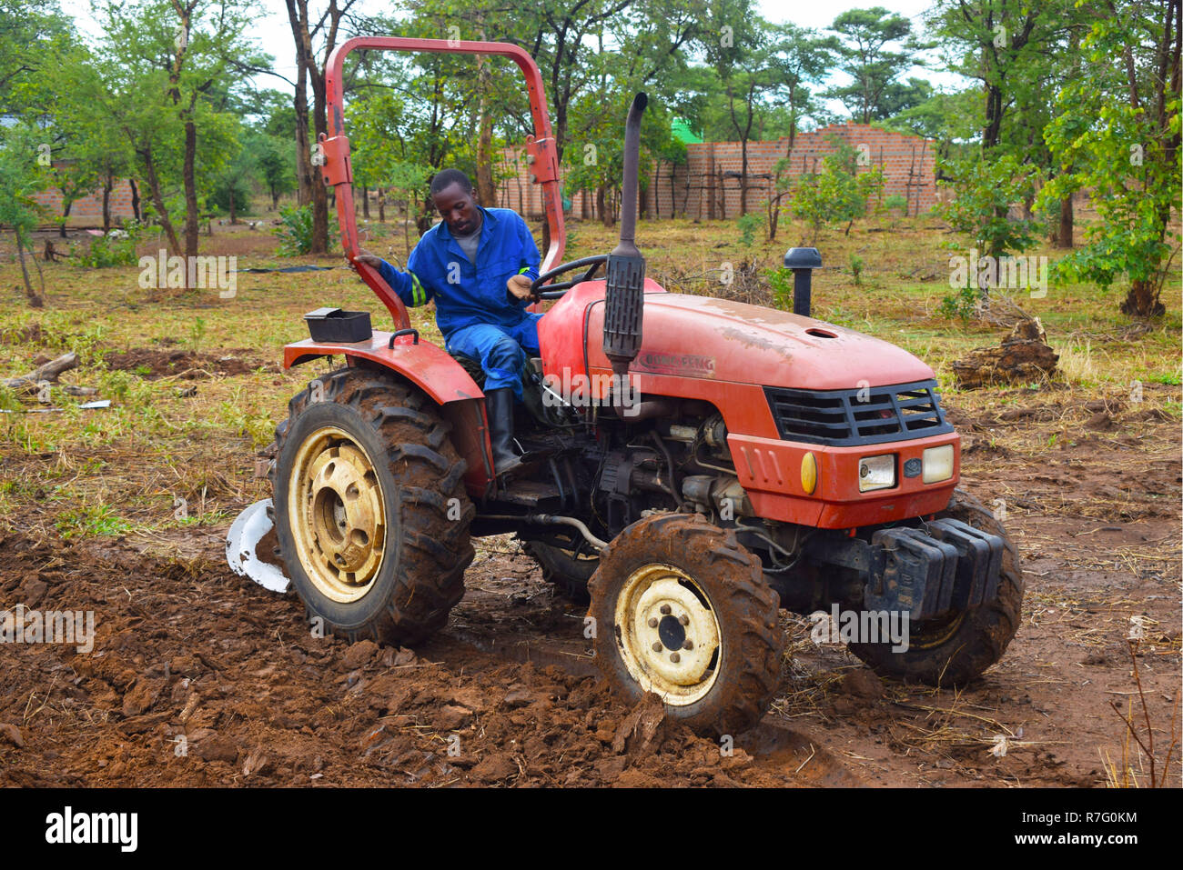 Male Farmer on a tractor in African field Stock Photo - Alamy