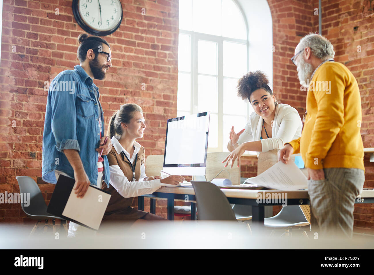 Conversation of colleagues Stock Photo - Alamy