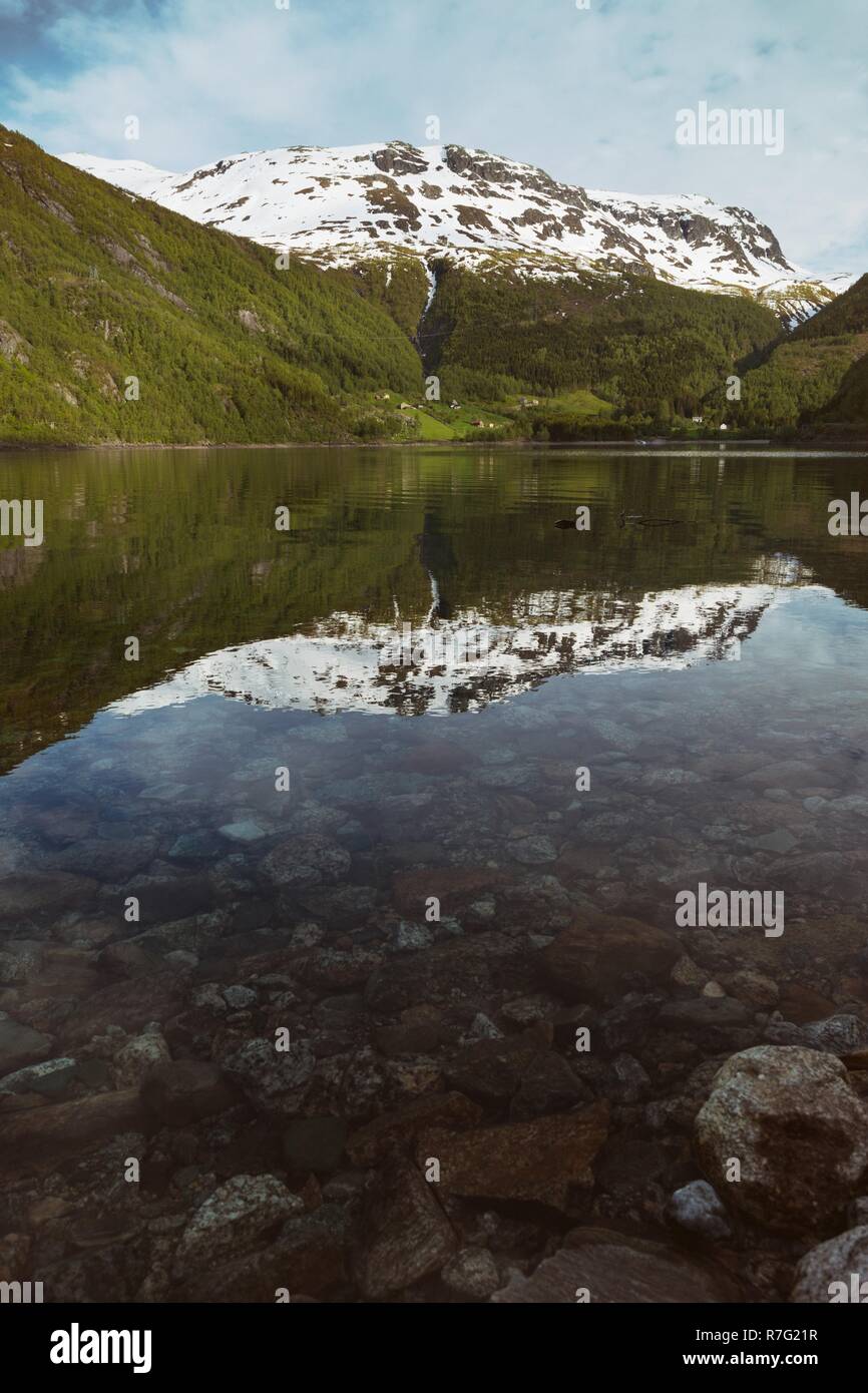 the beautiful Norwegian landscape. mountains in snow and reflection in water Stock Photo - Alamy