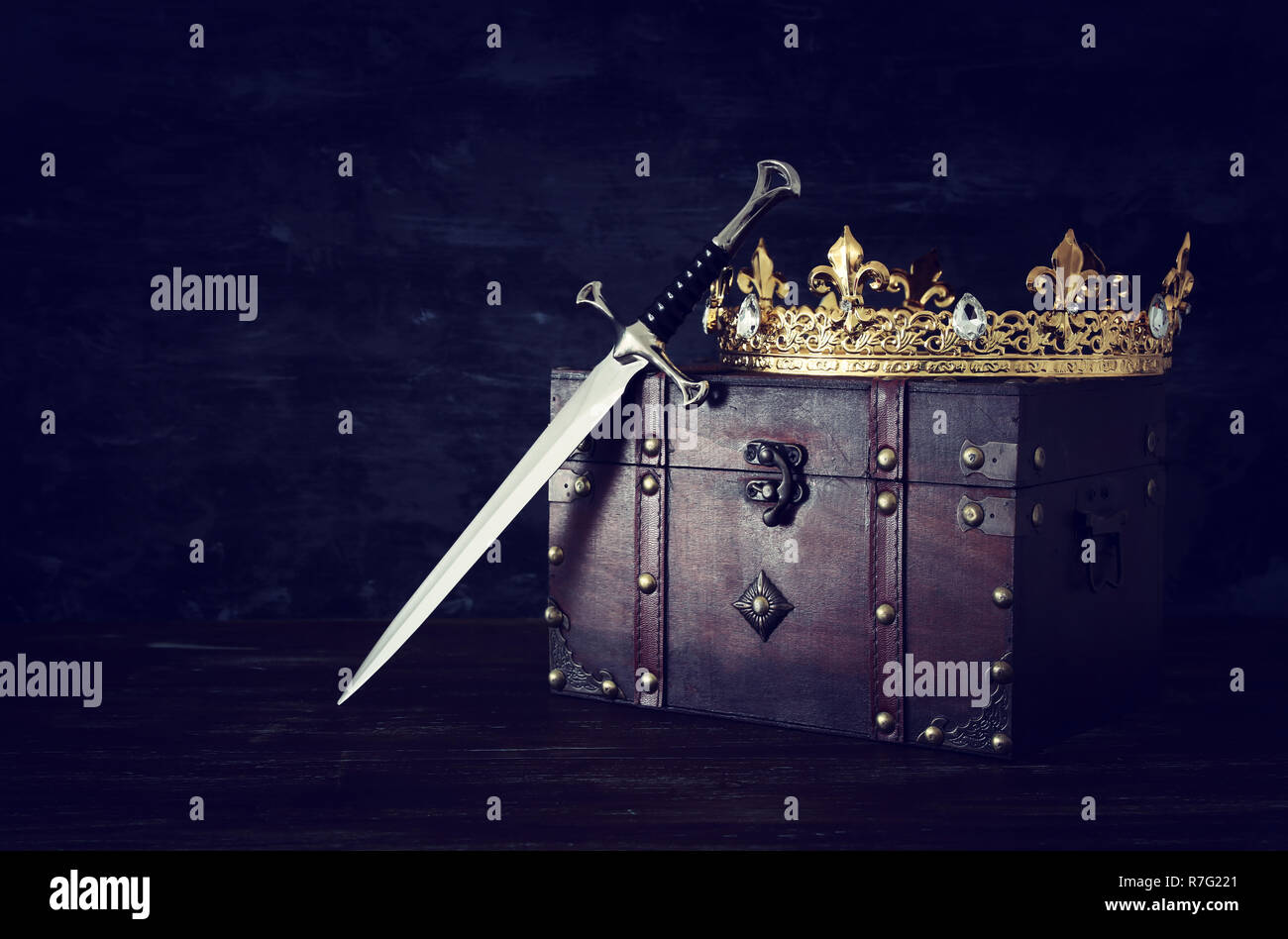 low key image of beautiful queen/king crown and sword. fantasy medieval ...