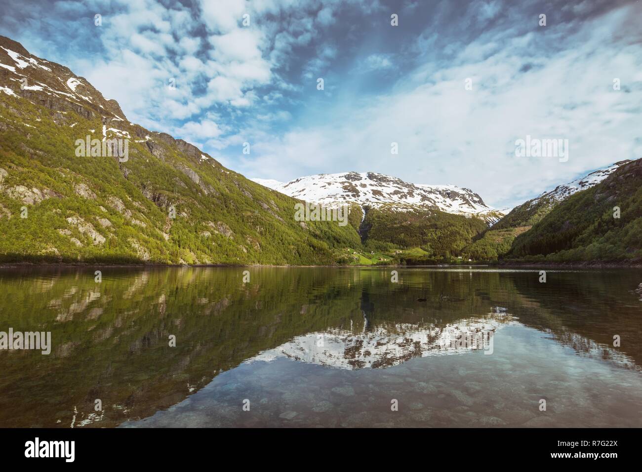 the beautiful Norwegian landscape. mountains in snow and reflection in water Stock Photo - Alamy