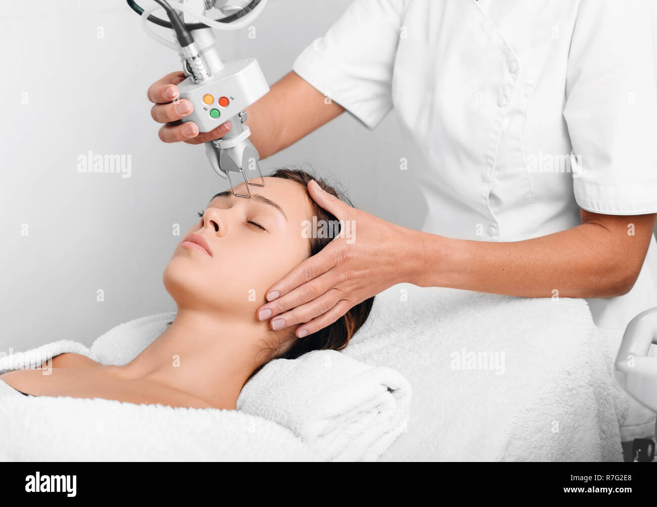 woman getting laser facial treatment, aesthetic surgery Stock Photo - Alamy