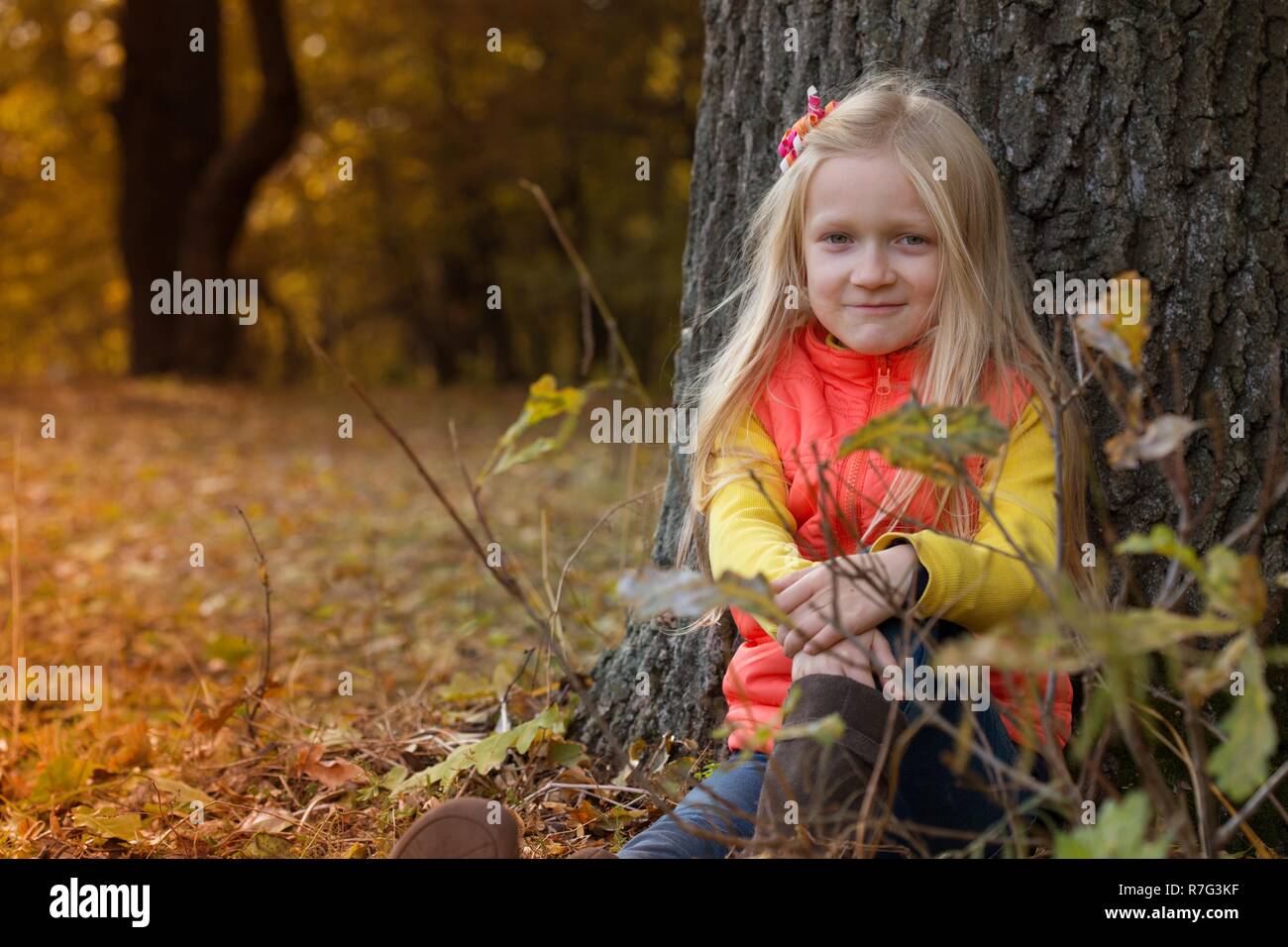 beautiful little girl in the autumn forest Stock Photo - Alamy