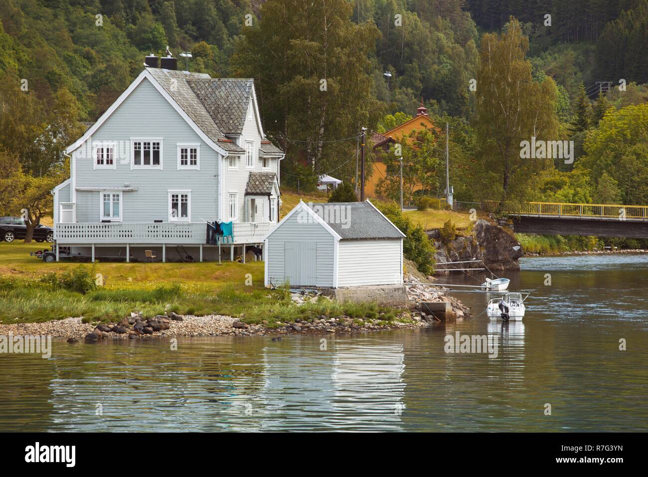 traditional norwegian wooden house to stand at the lakeside and ...
