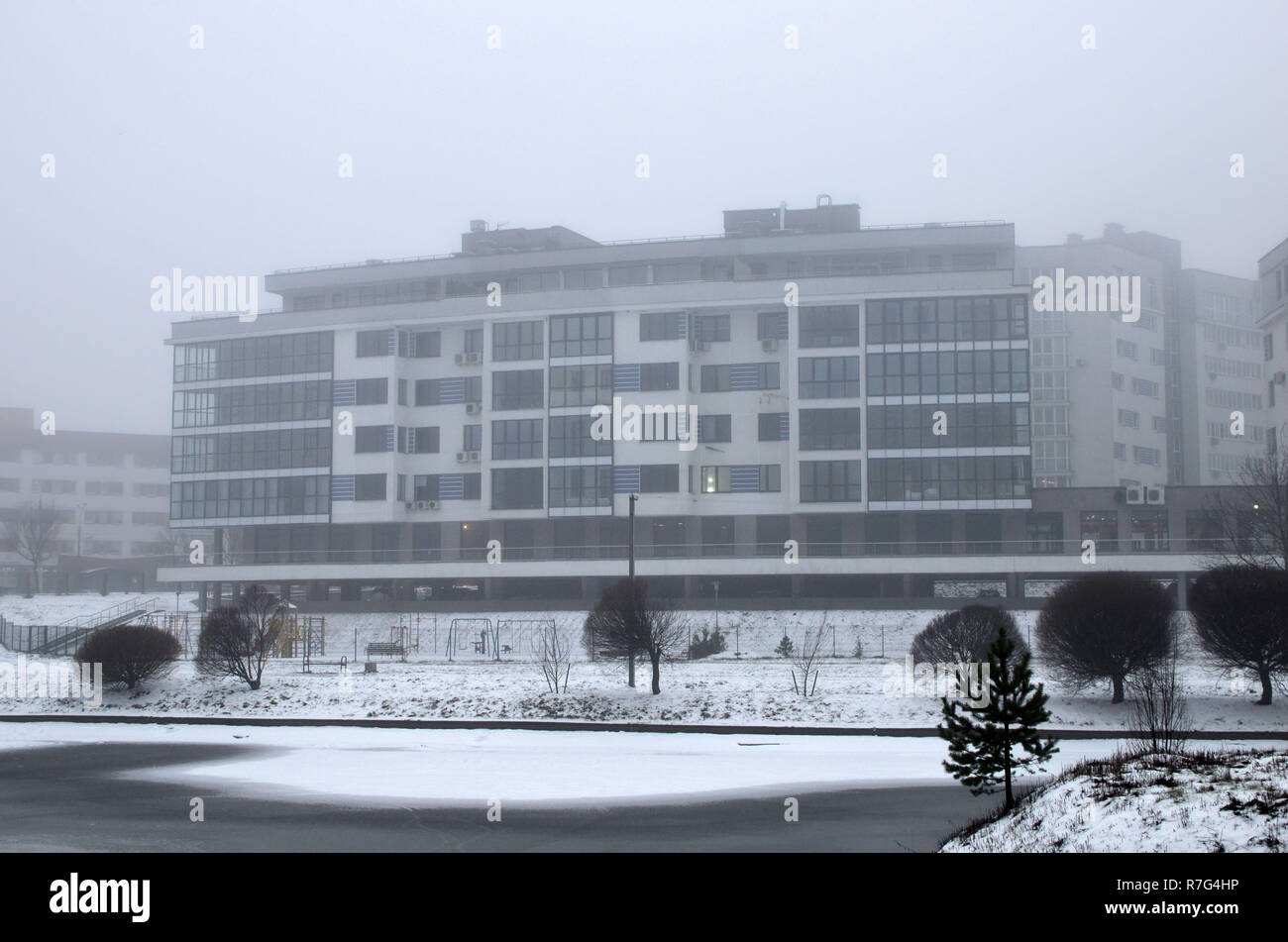 Design residential building against the backdrop of heavy fog and white ...