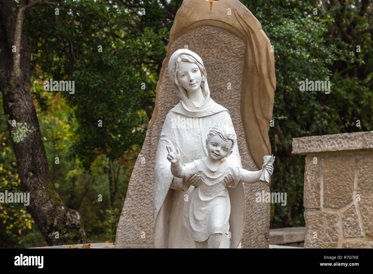 Statue of The Blessed Virgin Mary holding smiling Baby Jesus Stock ...